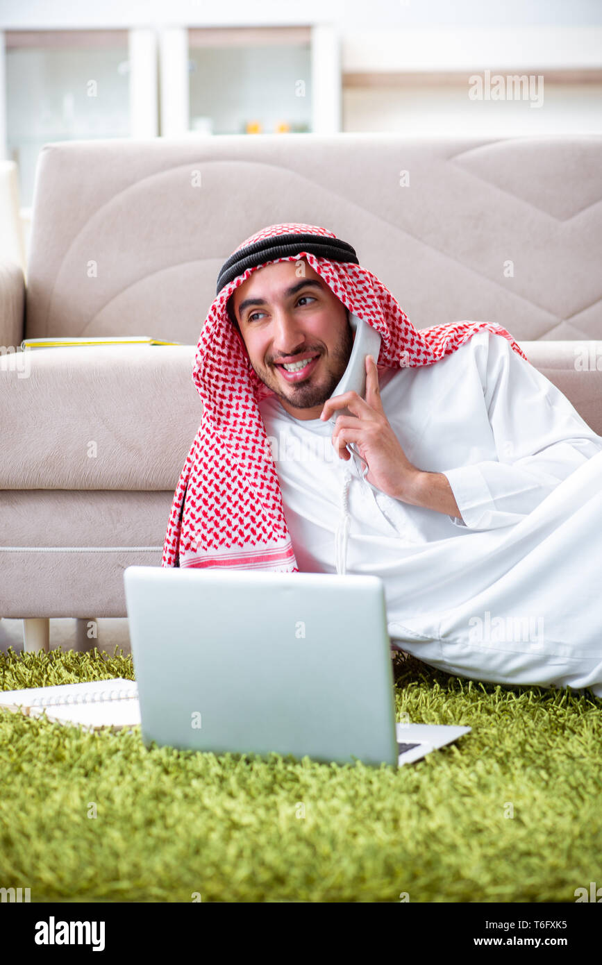Arab man working at home on his work Stock Photo - Alamy