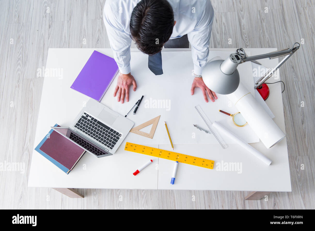 Engineer working on new project drawings Stock Photo - Alamy