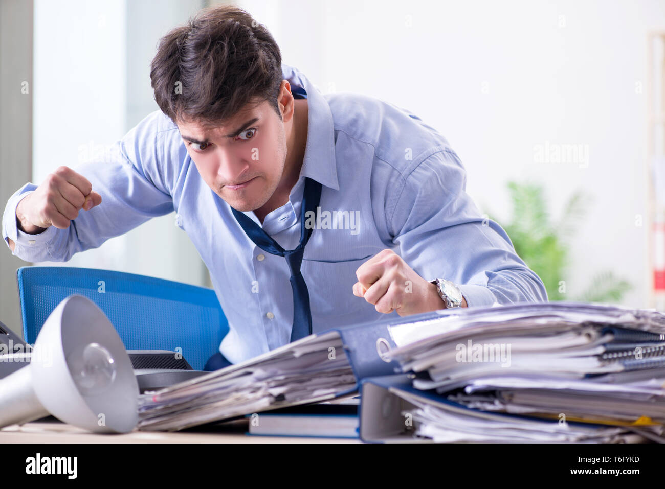 Angry businessman frustrated with too much work Stock Photo - Alamy