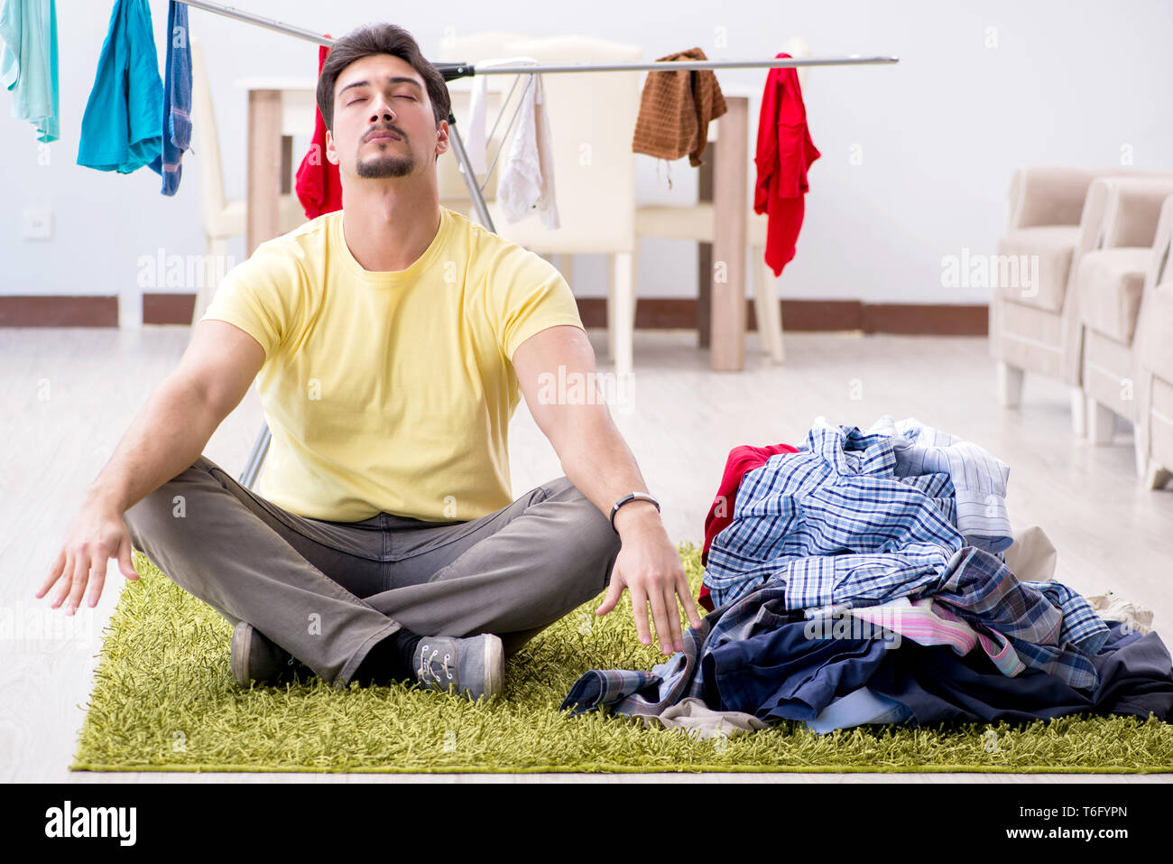 Handsome man husband doing laundering at home Stock Photo - Alamy
