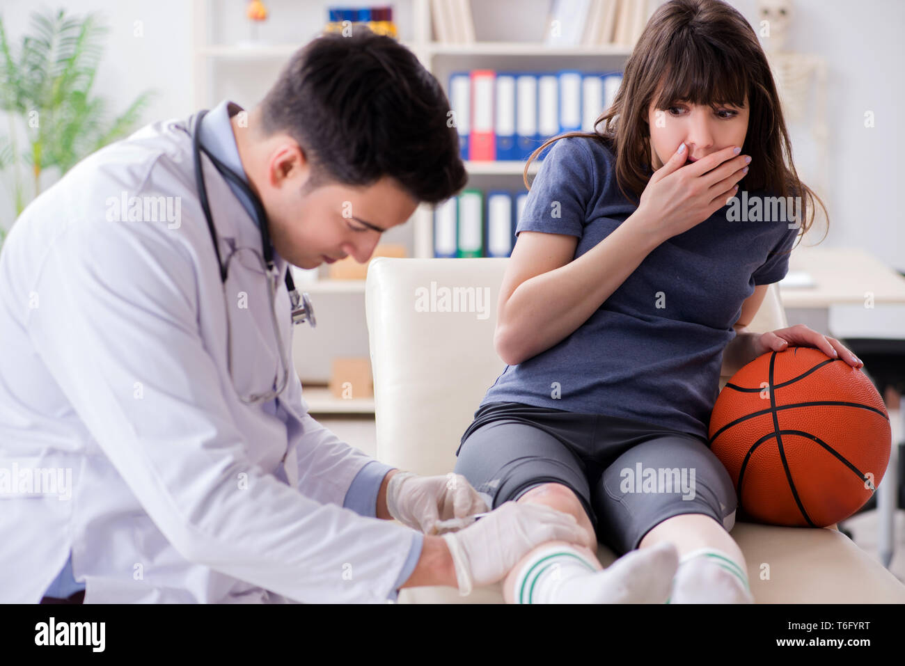 Female basketball player visiting doctor after injury Stock Photo - Alamy