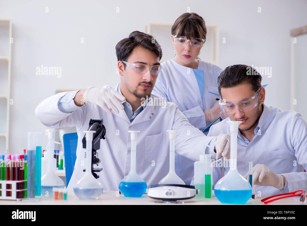 Team of chemists working in the lab Stock Photo - Alamy