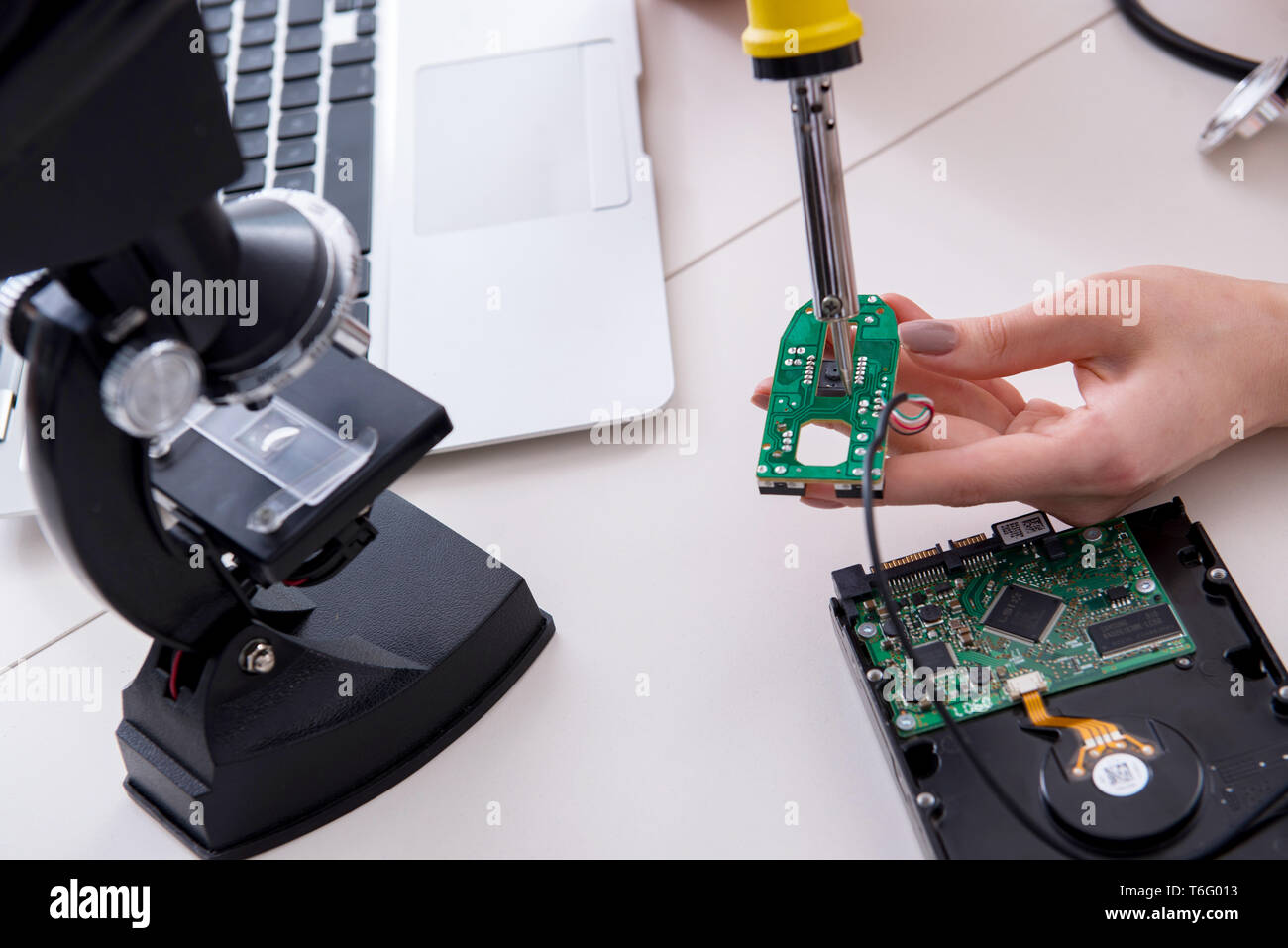 Engineer fixing broken computer hard drive Stock Photo - Alamy