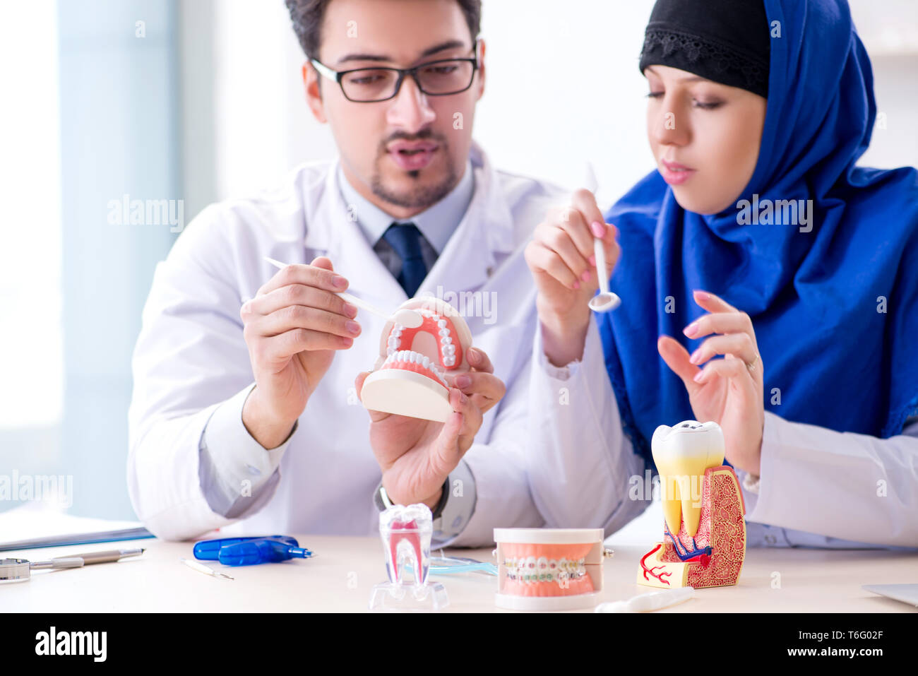 Dentist doctor and assistant working on new tooth implant Stock Photo ...