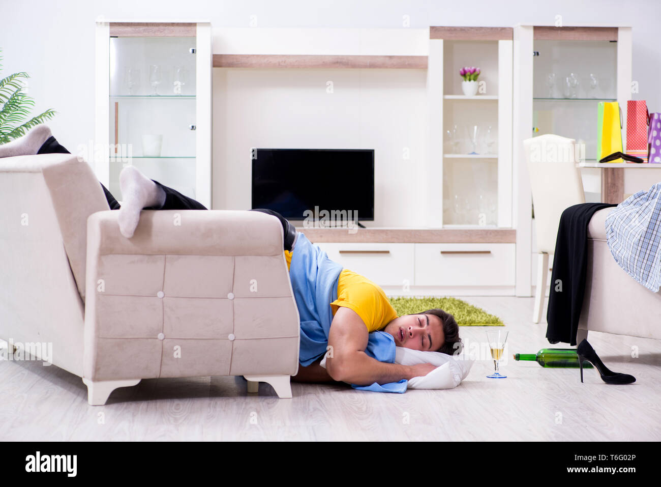 Man with mess at home after house party Stock Photo - Alamy