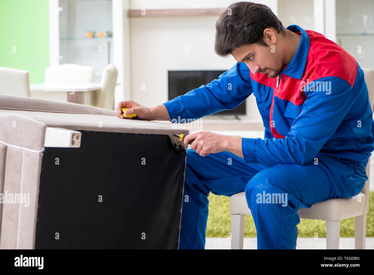 Repair contractor repairing broken furniture at home Stock Photo - Alamy