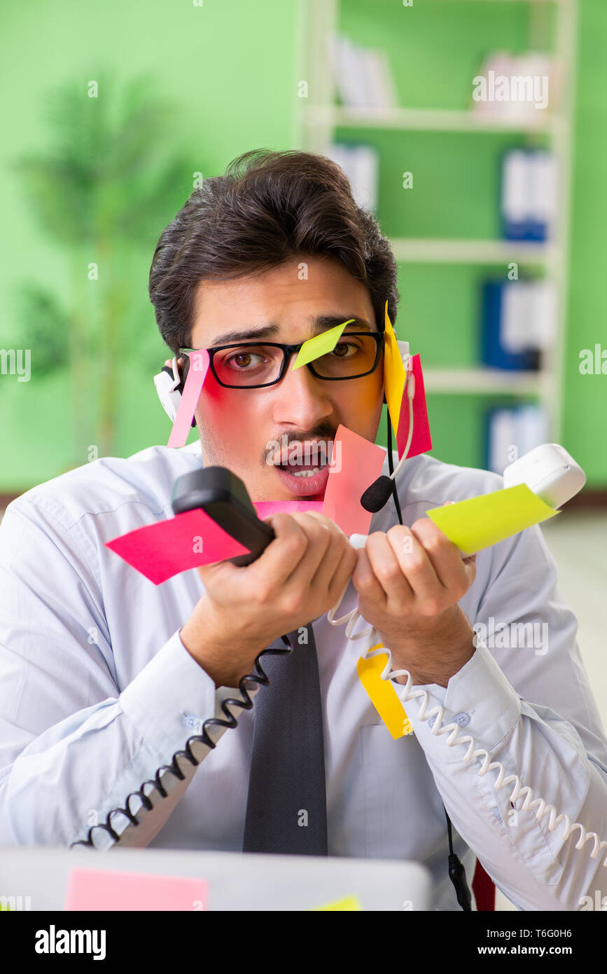 Young help desk operator working in office with many conflicting Stock ...