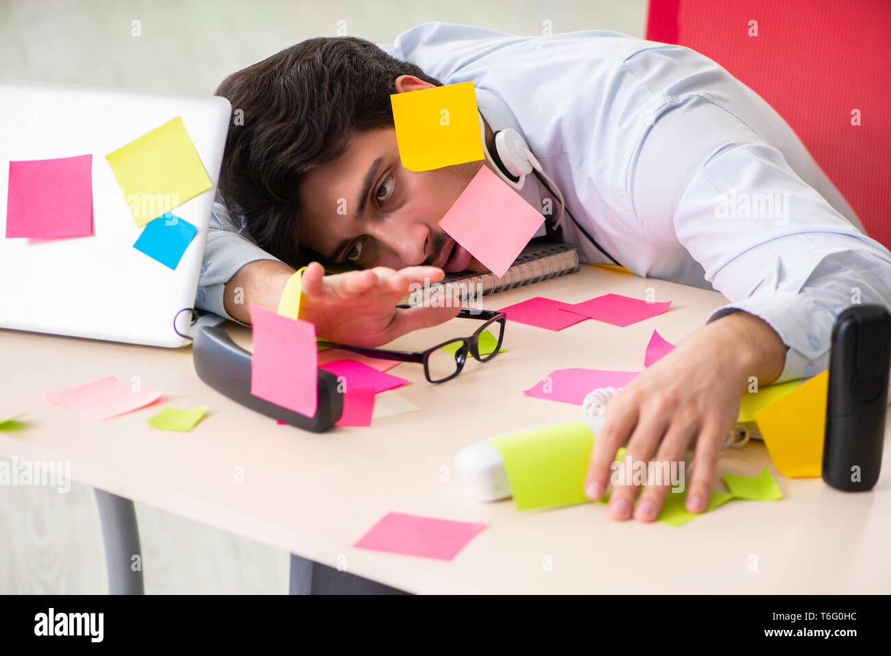 Young help desk operator working in office with many conflicting Stock ...