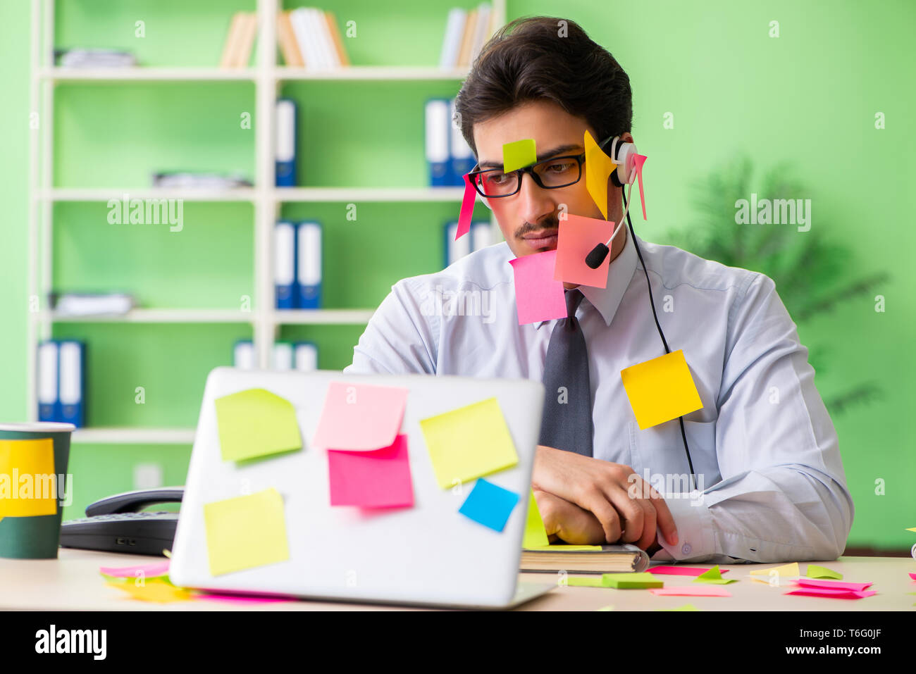 Young help desk operator working in office with many conflicting Stock ...