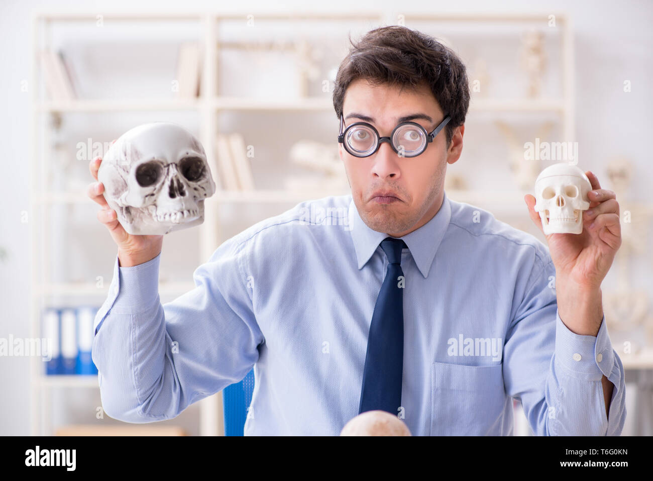 Funny crazy professor studying human skeleton Stock Photo - Alamy