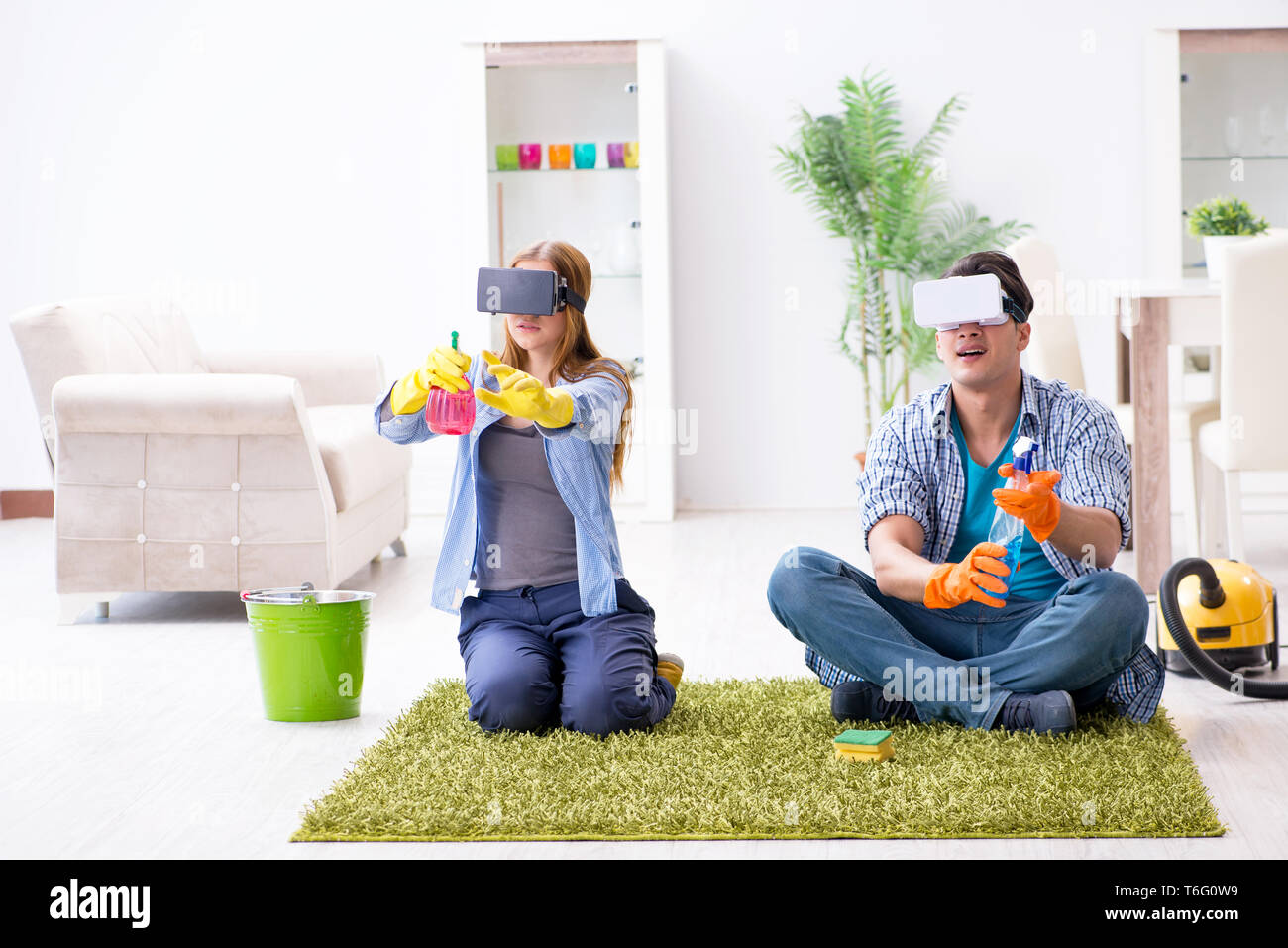 Pair cleaning house with virtual glasses Stock Photo - Alamy