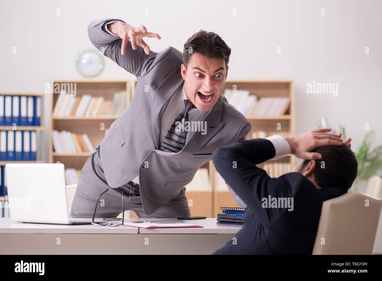Angry boss shouting at his employee Stock Photo - Alamy
