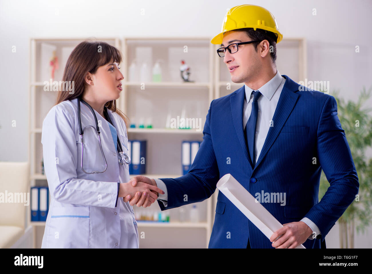 Doctor with a construction worker hi-res stock photography and images ...