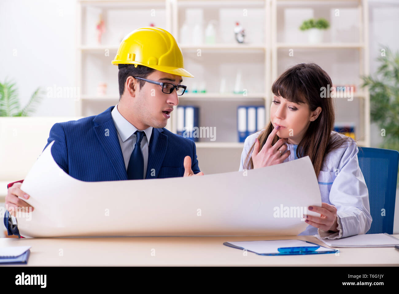 Doctor discussing new hospital plan with architect Stock Photo - Alamy