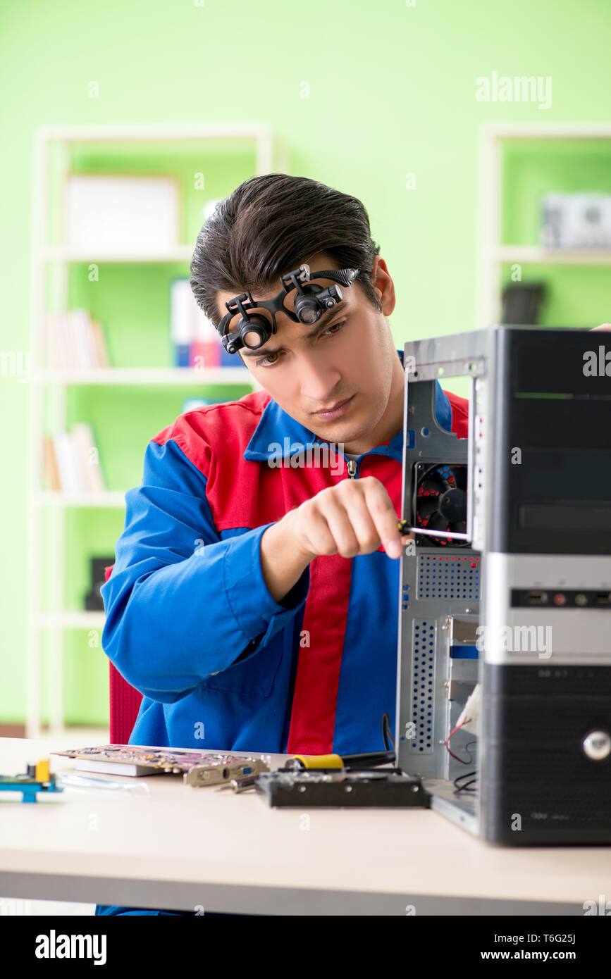 Computer engineer repairing broken desktop Stock Photo - Alamy