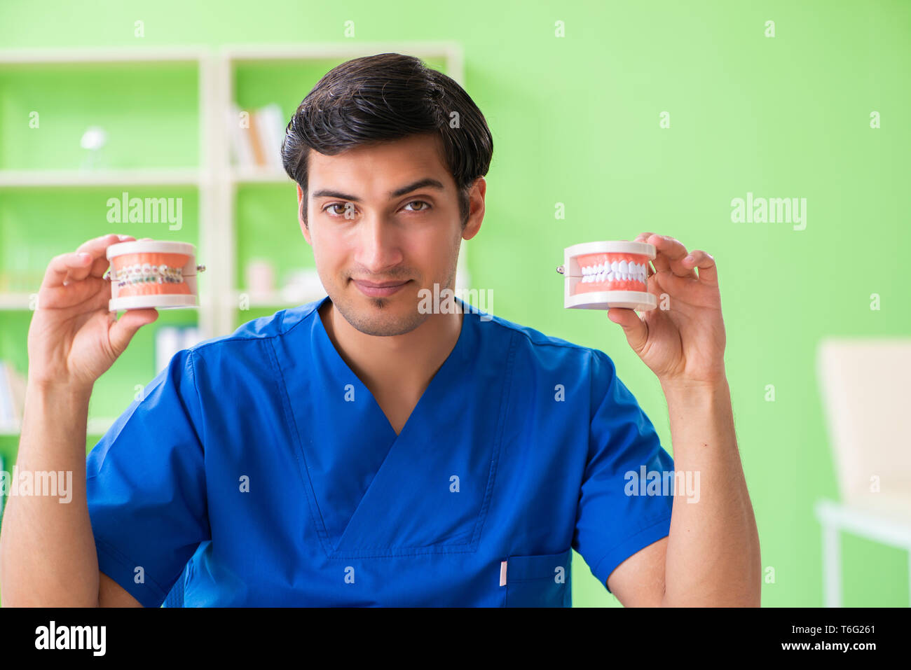 Man dentist working on new teeth implant Stock Photo - Alamy