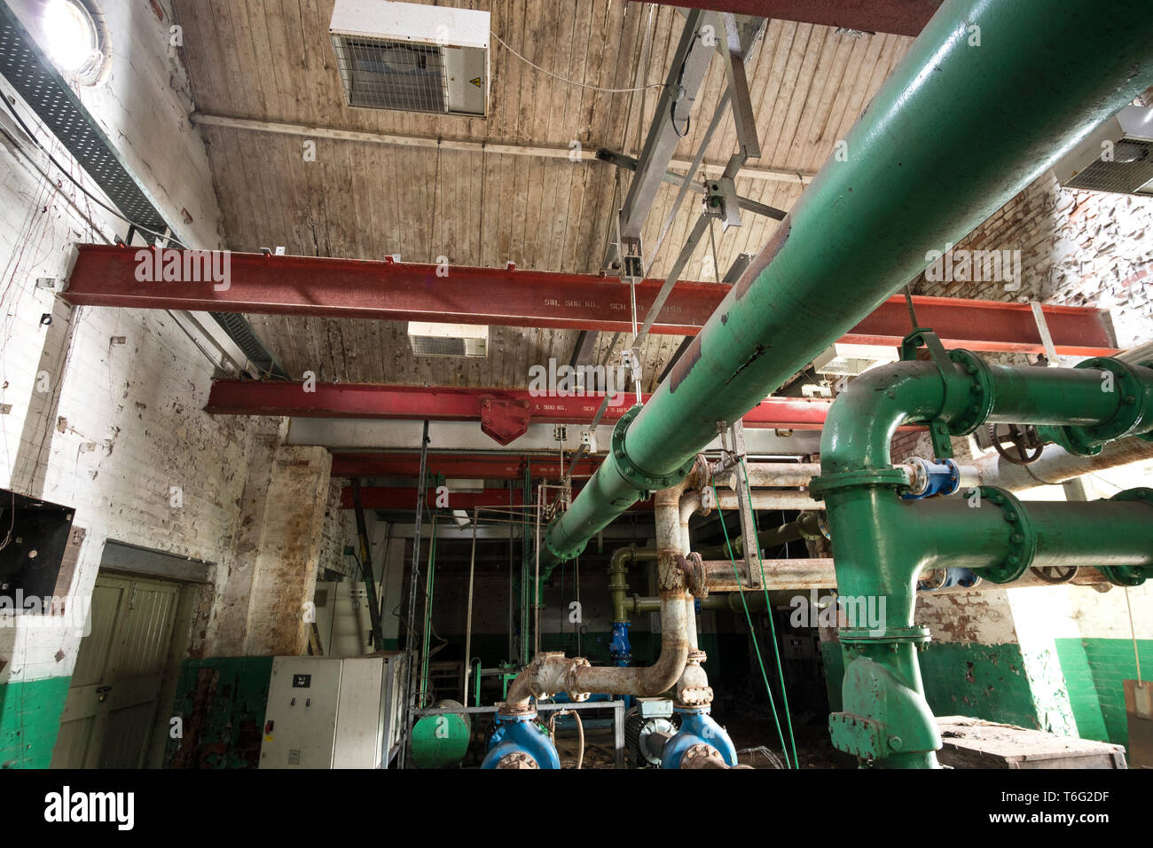 Abandoned water pump room interior showing pipework and valves Stock ...