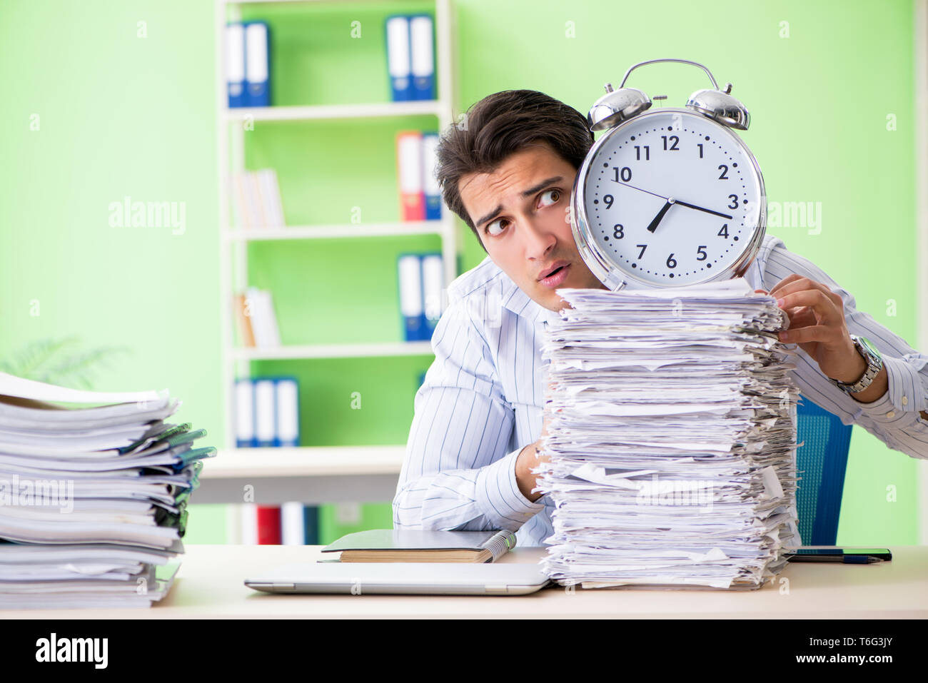 Businessman having problems with paperwork and workload Stock Photo - Alamy
