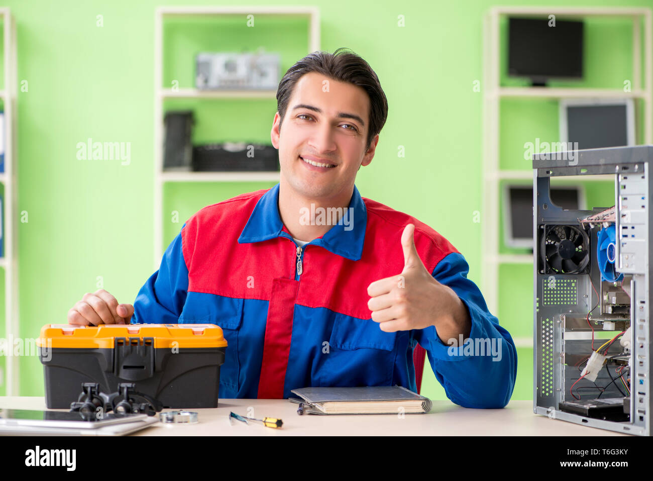 Computer engineer repairing broken desktop Stock Photo - Alamy