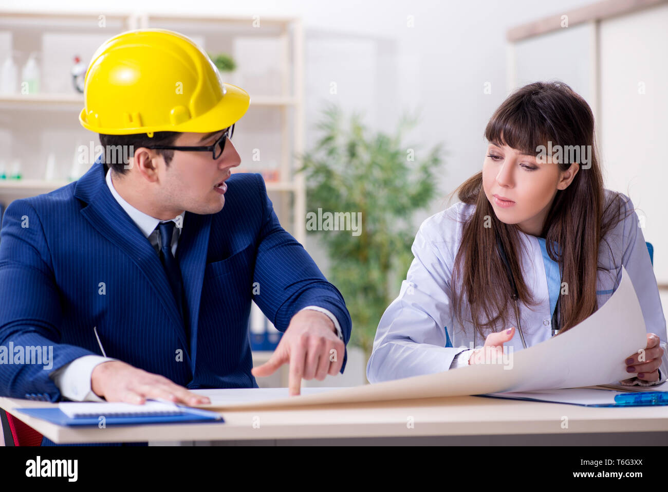 Doctor discussing new hospital plan with architect Stock Photo - Alamy