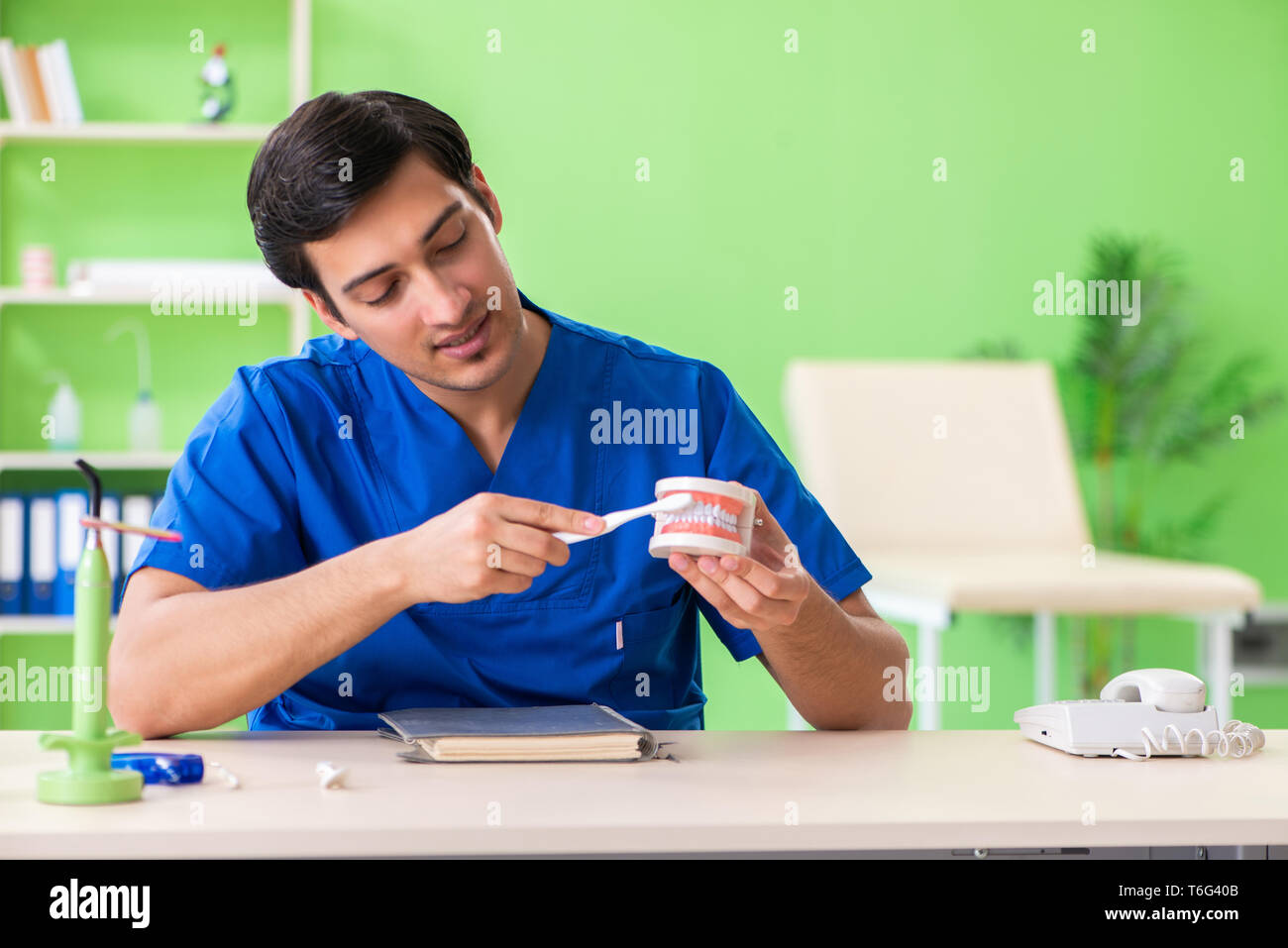 Man dentist working on new teeth implant Stock Photo - Alamy