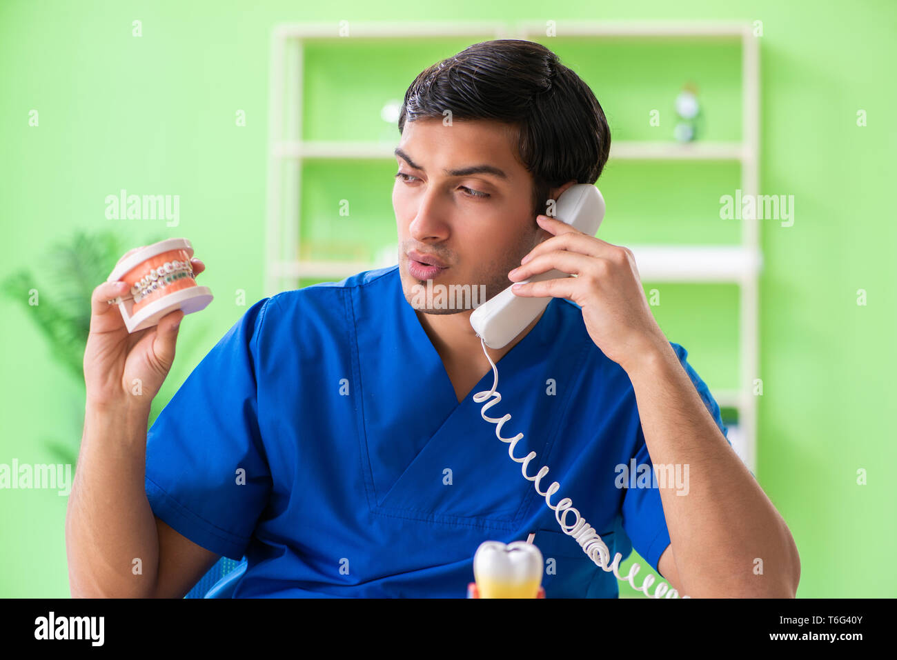 Man dentist working on new teeth implant Stock Photo - Alamy