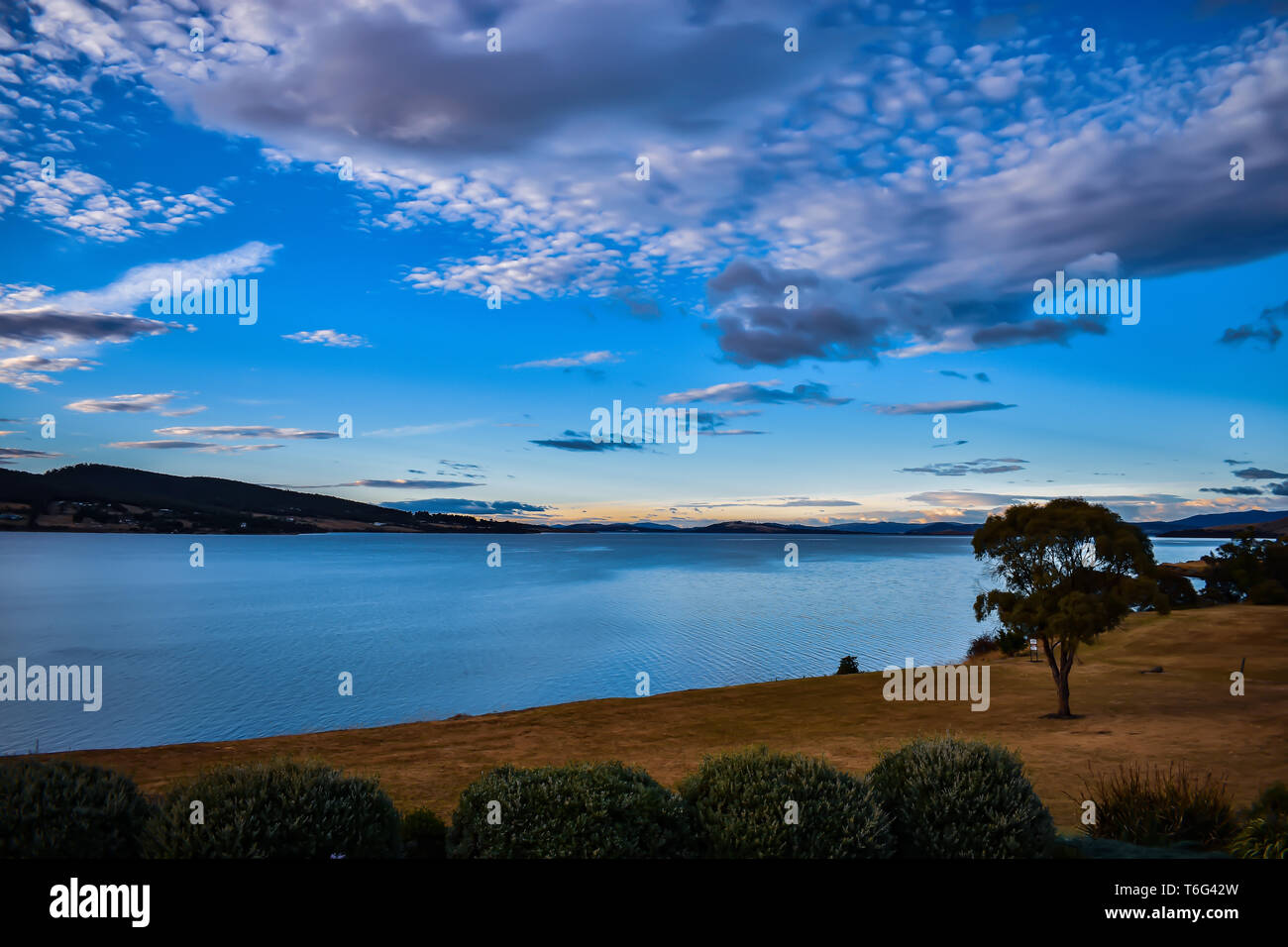Sun setting on Ralphs Bay, Tasmania looking out from Lauderdale Stock ...