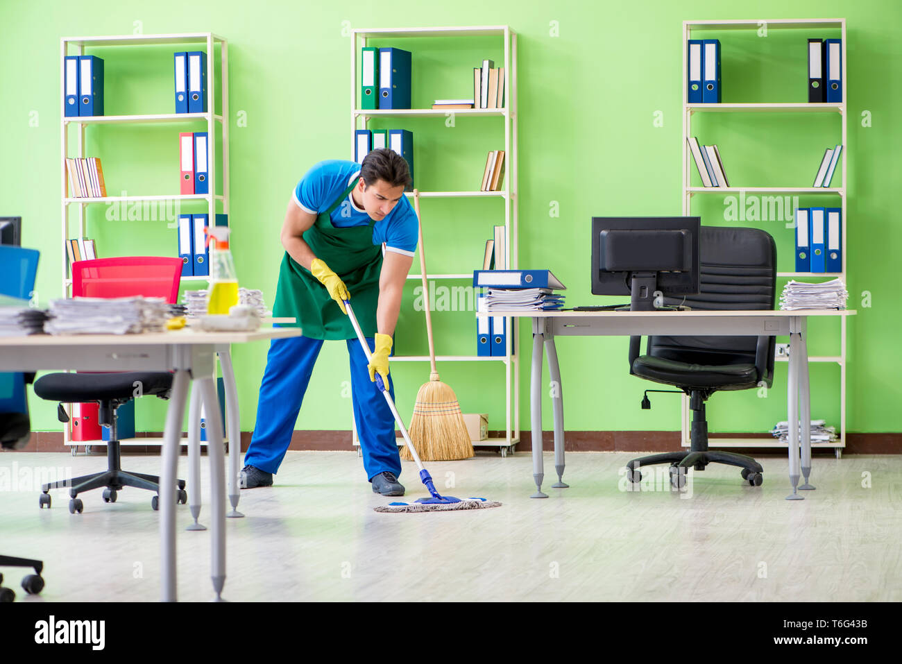 Male handsome professional cleaner doing mopping in the office Stock ...