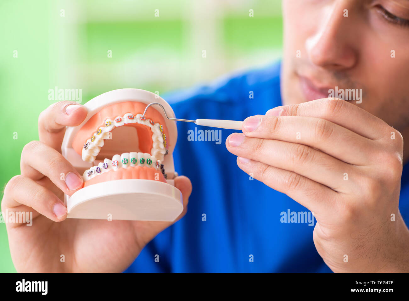 Man dentist working on new teeth implant Stock Photo - Alamy