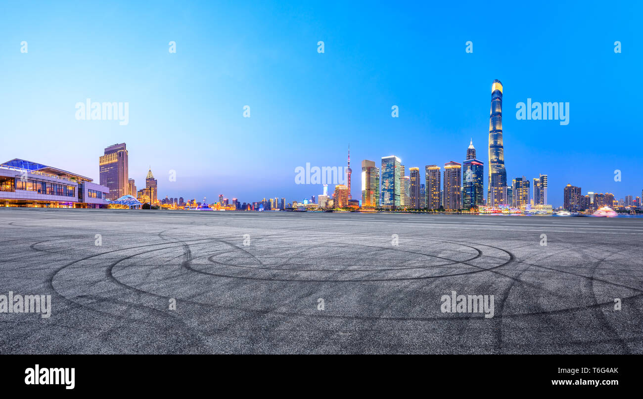 Asphalt race track ground and modern skyline and buildings in Shanghai ...