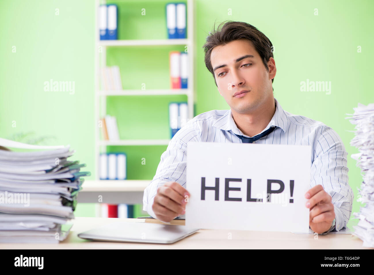 Businessman having problems with paperwork and workload Stock Photo - Alamy