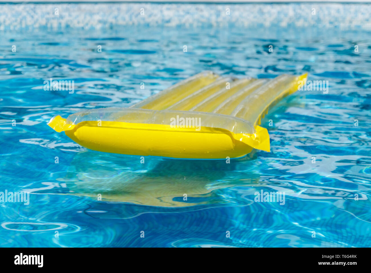 Inflatable water activities mattresses float on the water in the pool ...