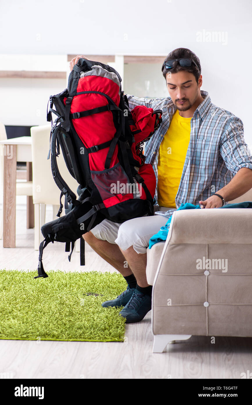 Backpacker packing for his trip Stock Photo - Alamy