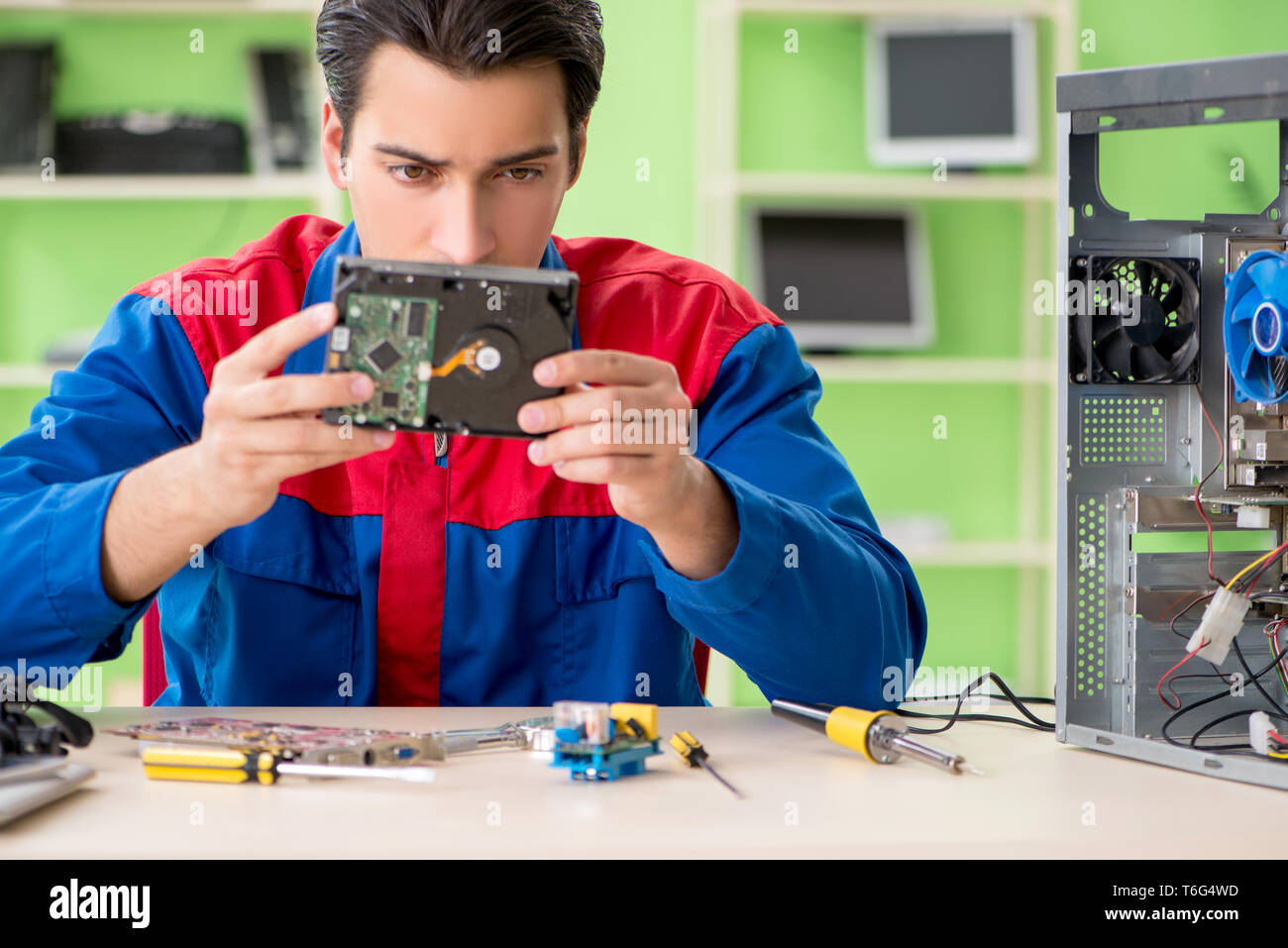 Computer engineer repairing broken desktop Stock Photo - Alamy