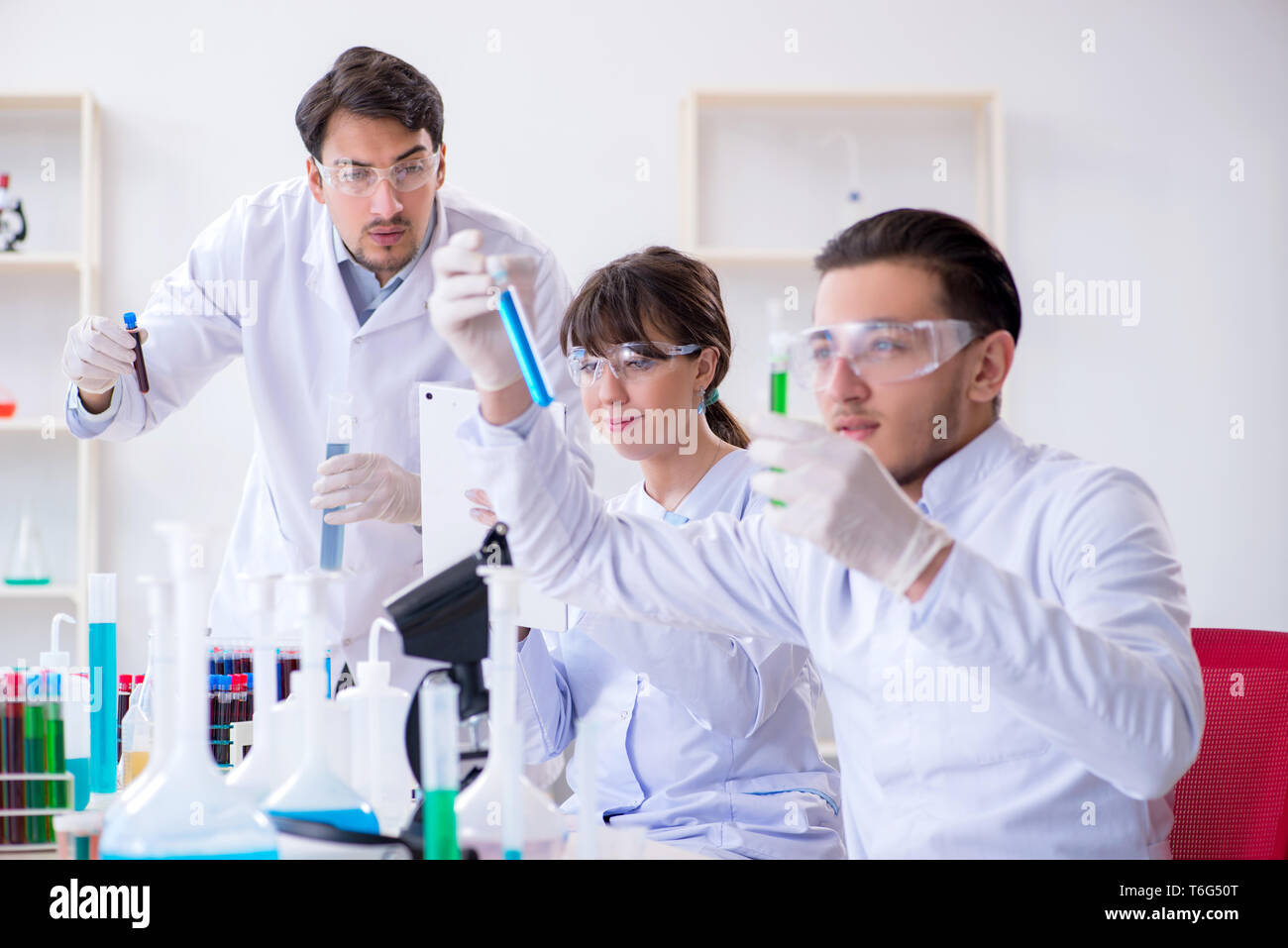 Team of chemists working in the lab Stock Photo - Alamy