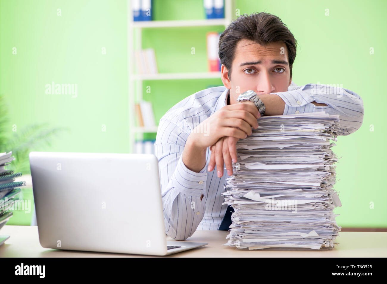 Businessman having problems with paperwork and workload Stock Photo - Alamy