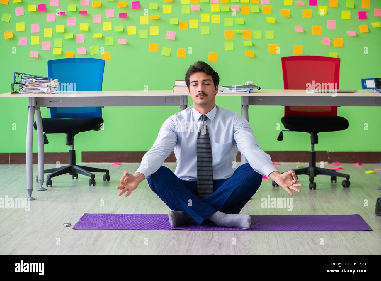 Man in the office with many conflicting priorities doing exercis Stock ...