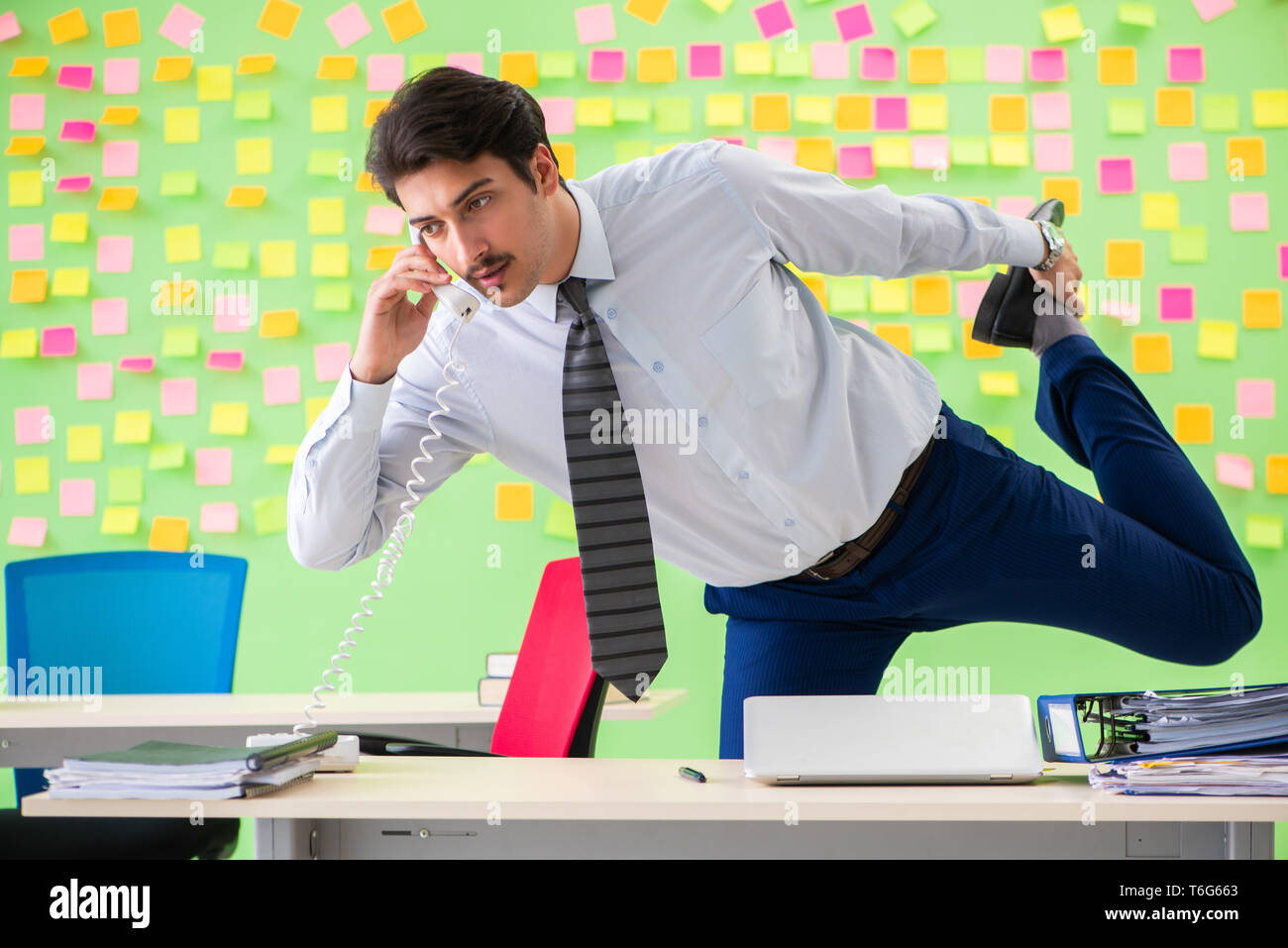 Man in the office with many conflicting priorities doing exercis Stock ...