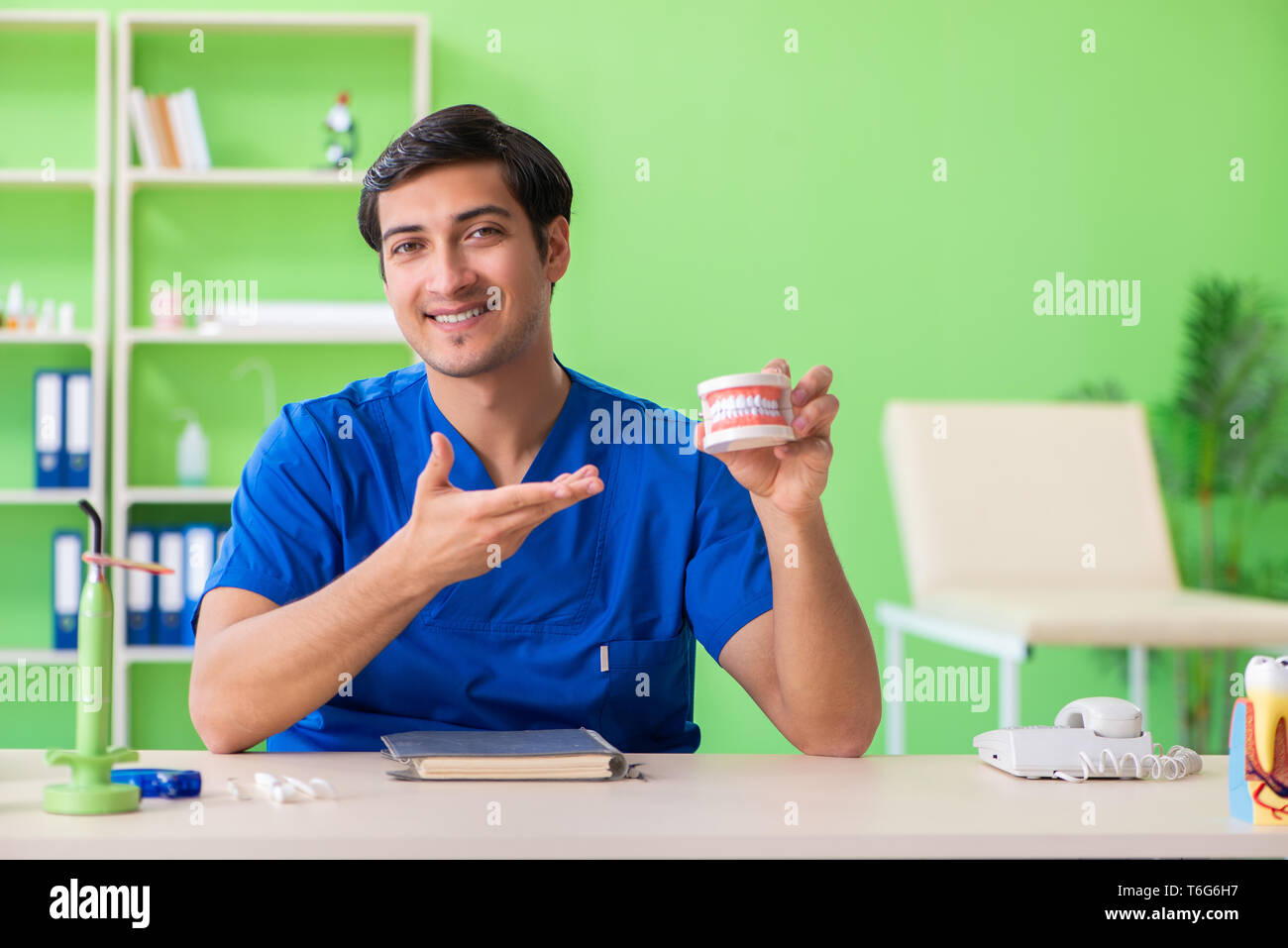 Man dentist working on new teeth implant Stock Photo - Alamy