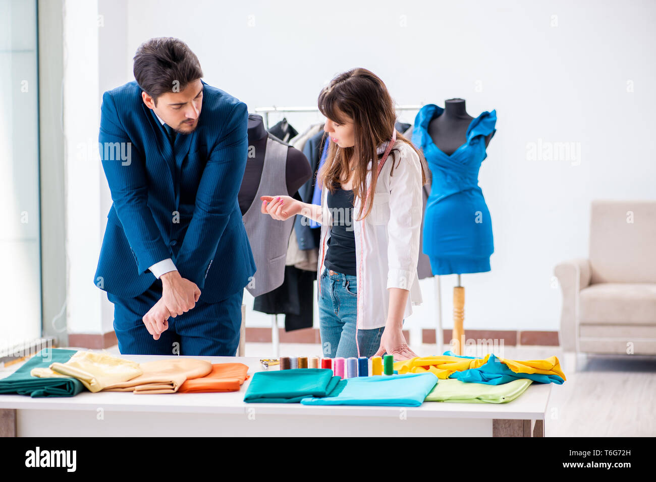 Professional tailor taking measurements for formal suit Stock Photo - Alamy