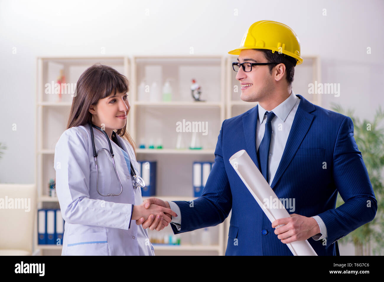 Doctor discussing new hospital plan with architect Stock Photo - Alamy