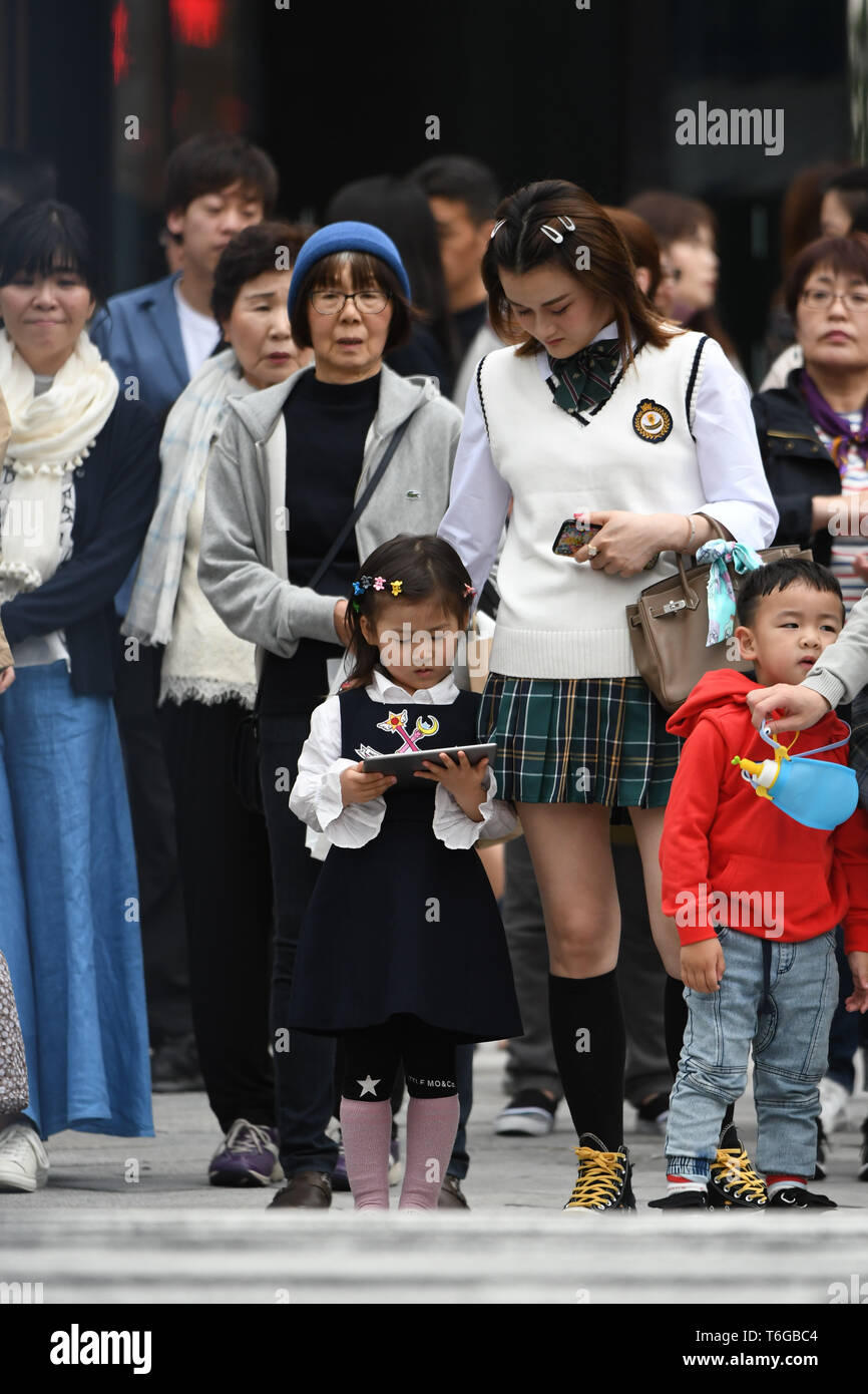 Tokyo, Japan. 1st May, 2019. People gets ready to cross the street on ...