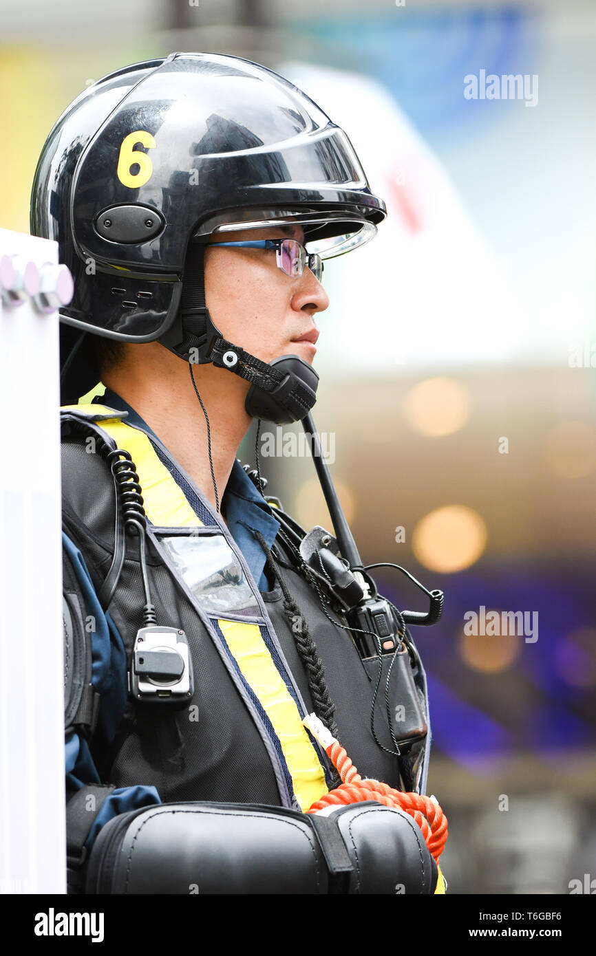 Tokyo, Japan. 1st May, 2019. A riots police man stands on a street of ...