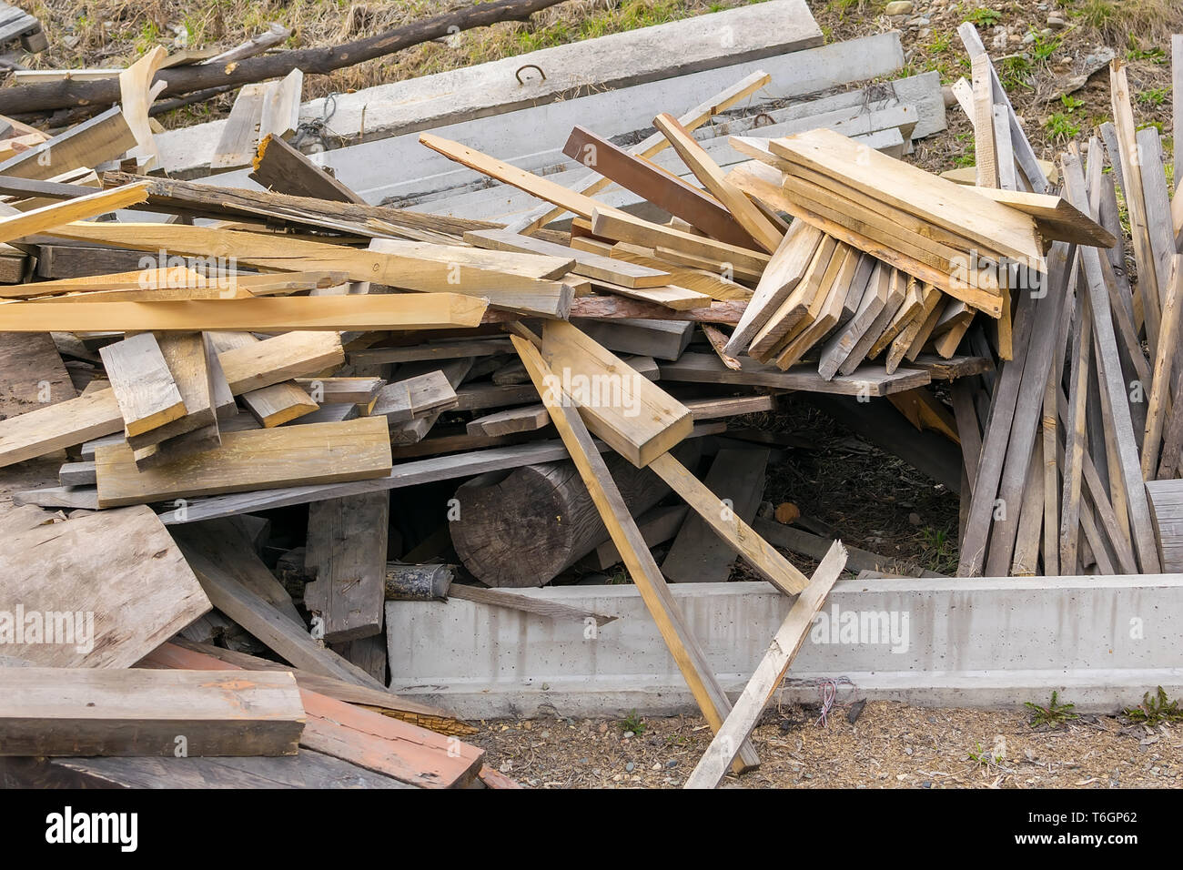 Piled in a pile of debris, pieces of boards, plywood and concrete ...
