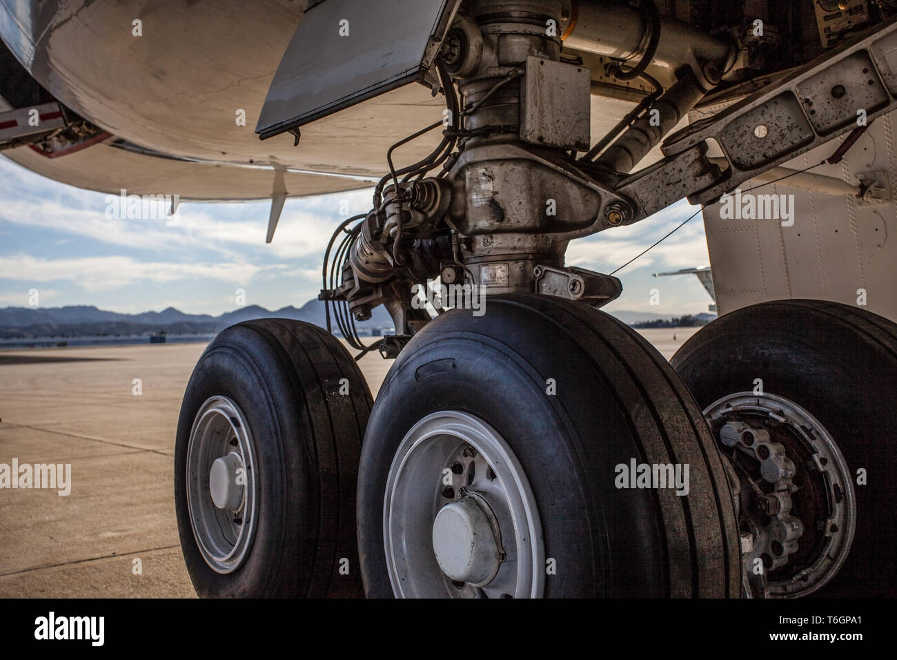 Aviation: Huge airplane wheels with black tires on tarmac Stock Photo ...