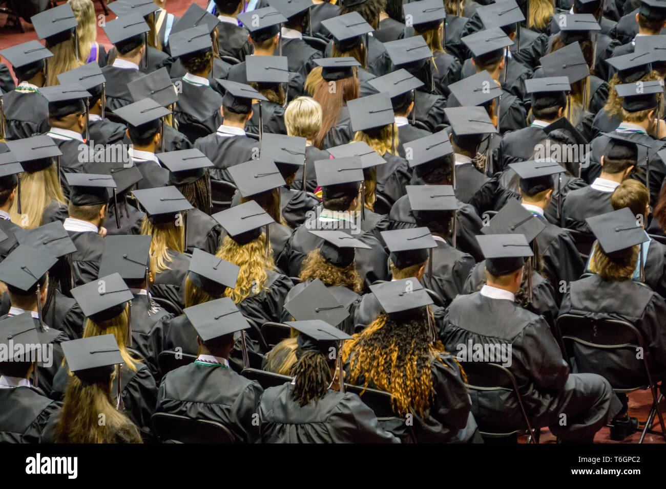 crowd of graduates standing at ceremony Stock Photo - Alamy
