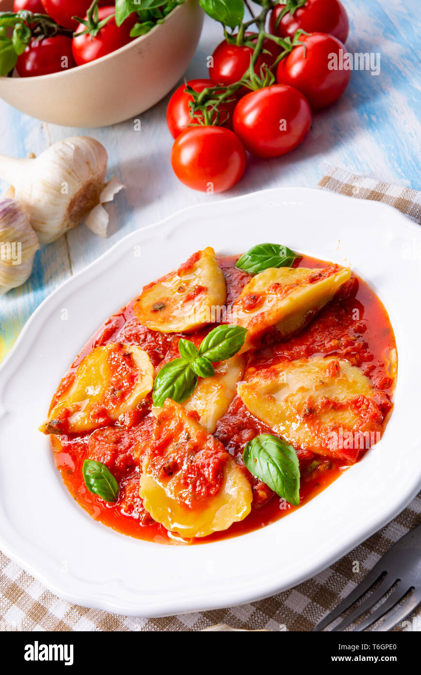 Delicious pasta - ravioli in tomato sauce with basil Stock Photo - Alamy