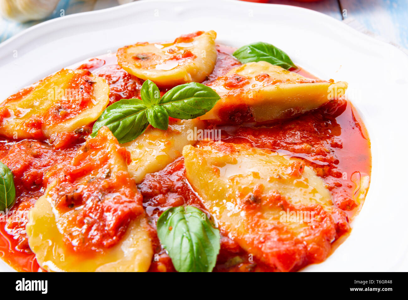 Delicious pasta - ravioli in tomato sauce with basil Stock Photo - Alamy