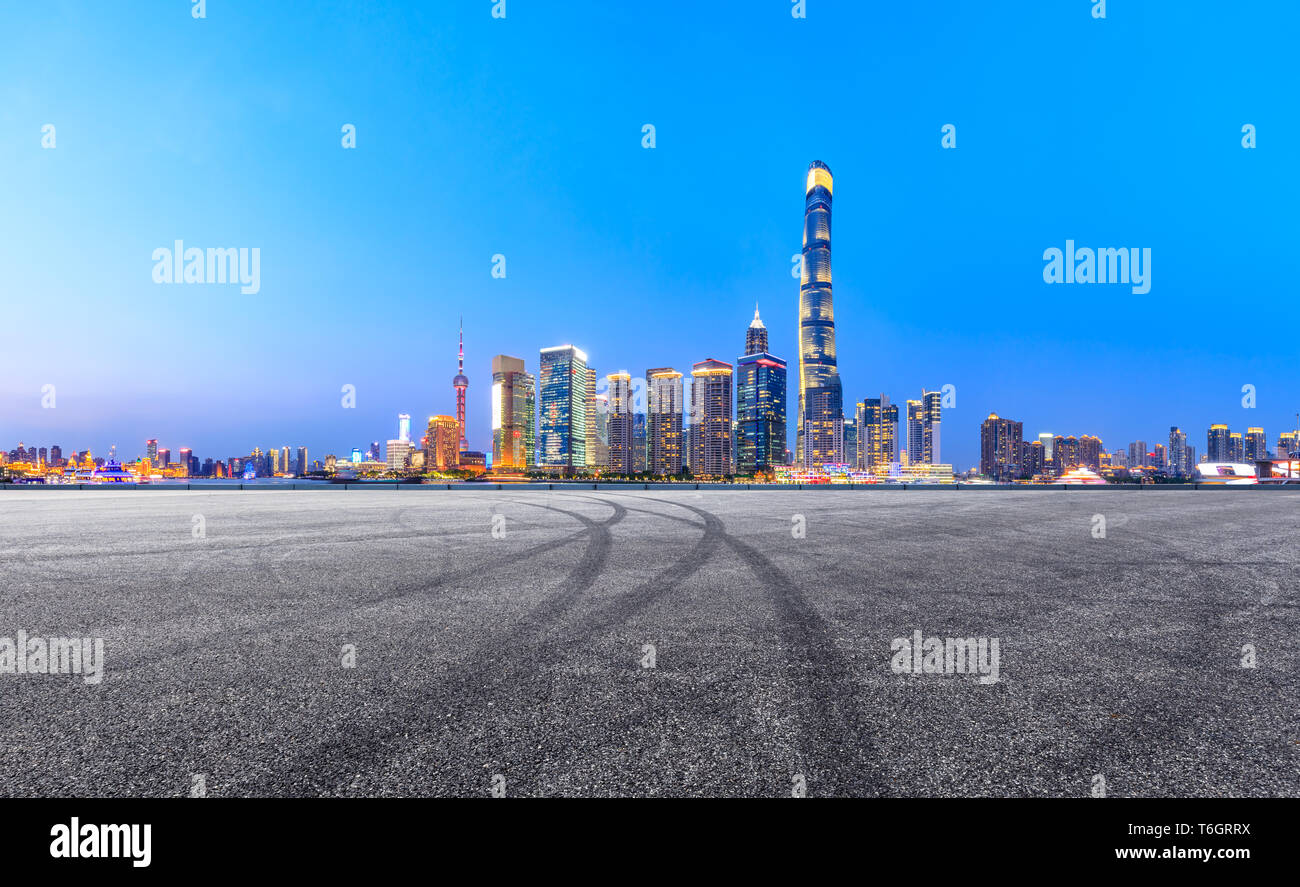 Asphalt race track ground and modern skyline and buildings in Shanghai ...