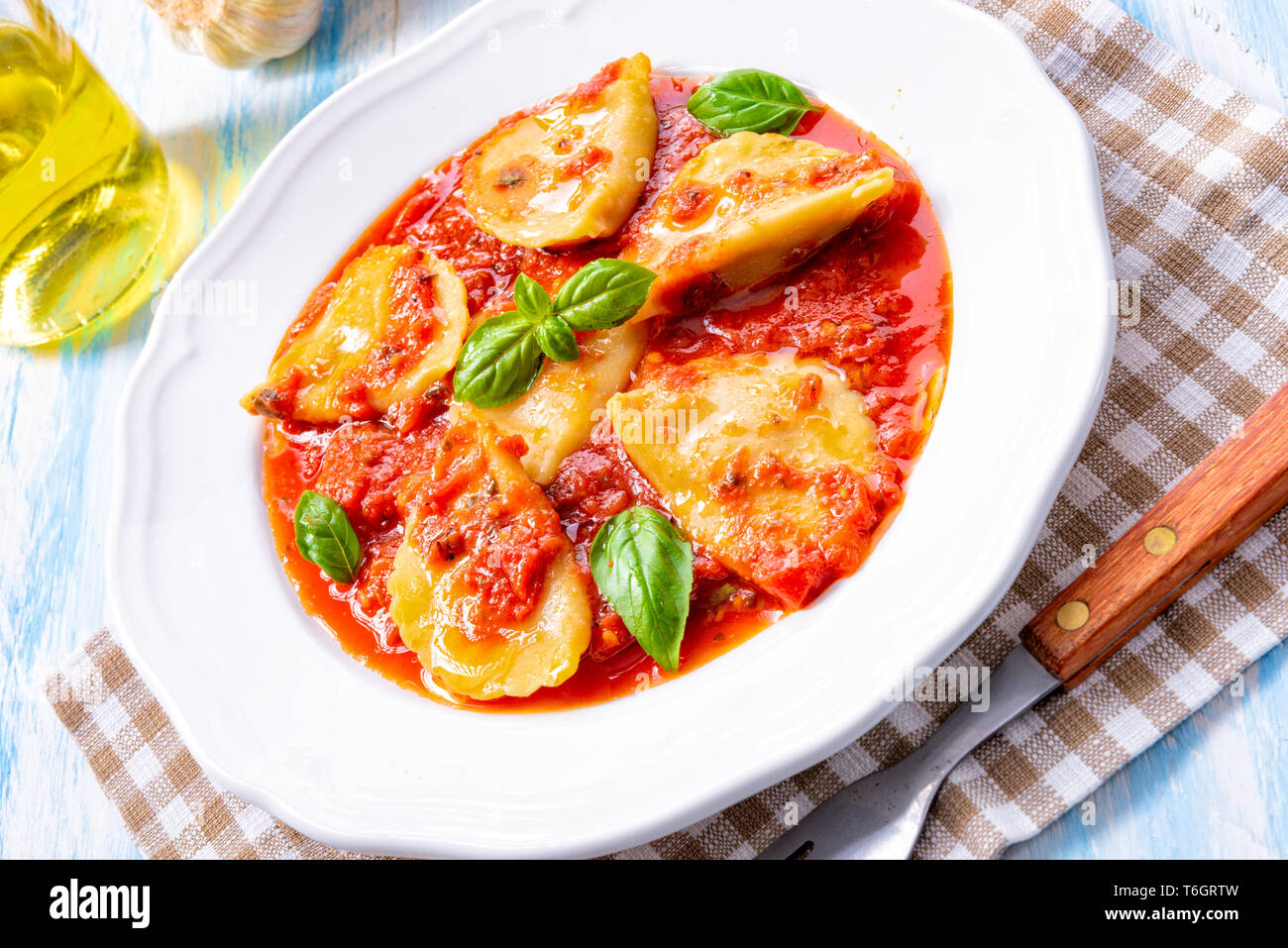 Delicious pasta - ravioli in tomato sauce with basil Stock Photo - Alamy